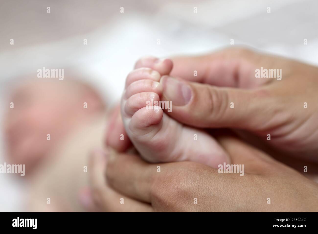 Mother massaging the baby foot at home Stock Photo - Alamy
