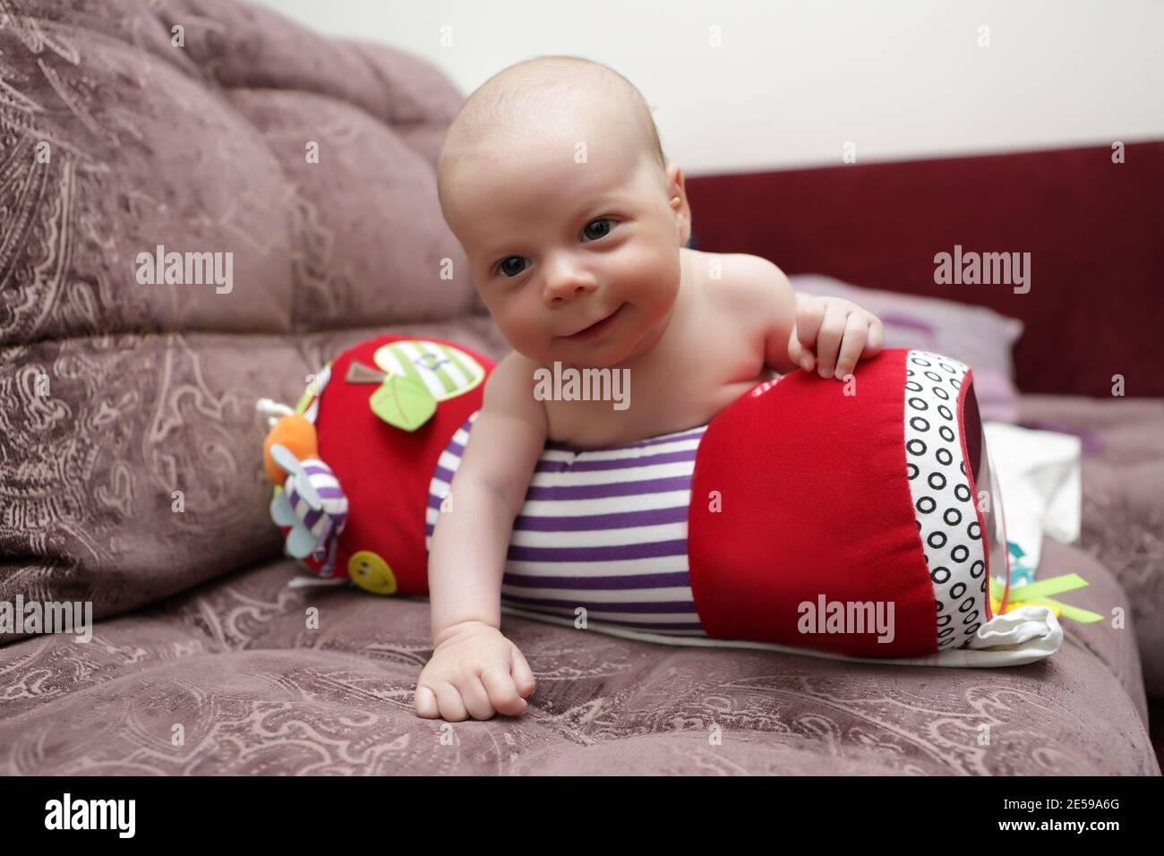 Portrait of smiling baby on crawling roll Stock Photo - Alamy