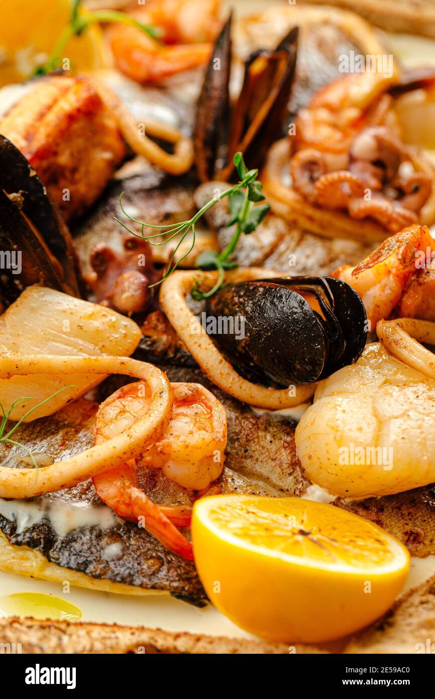 Closeup on seafood saute mix with cream sauce Stock Photo - Alamy