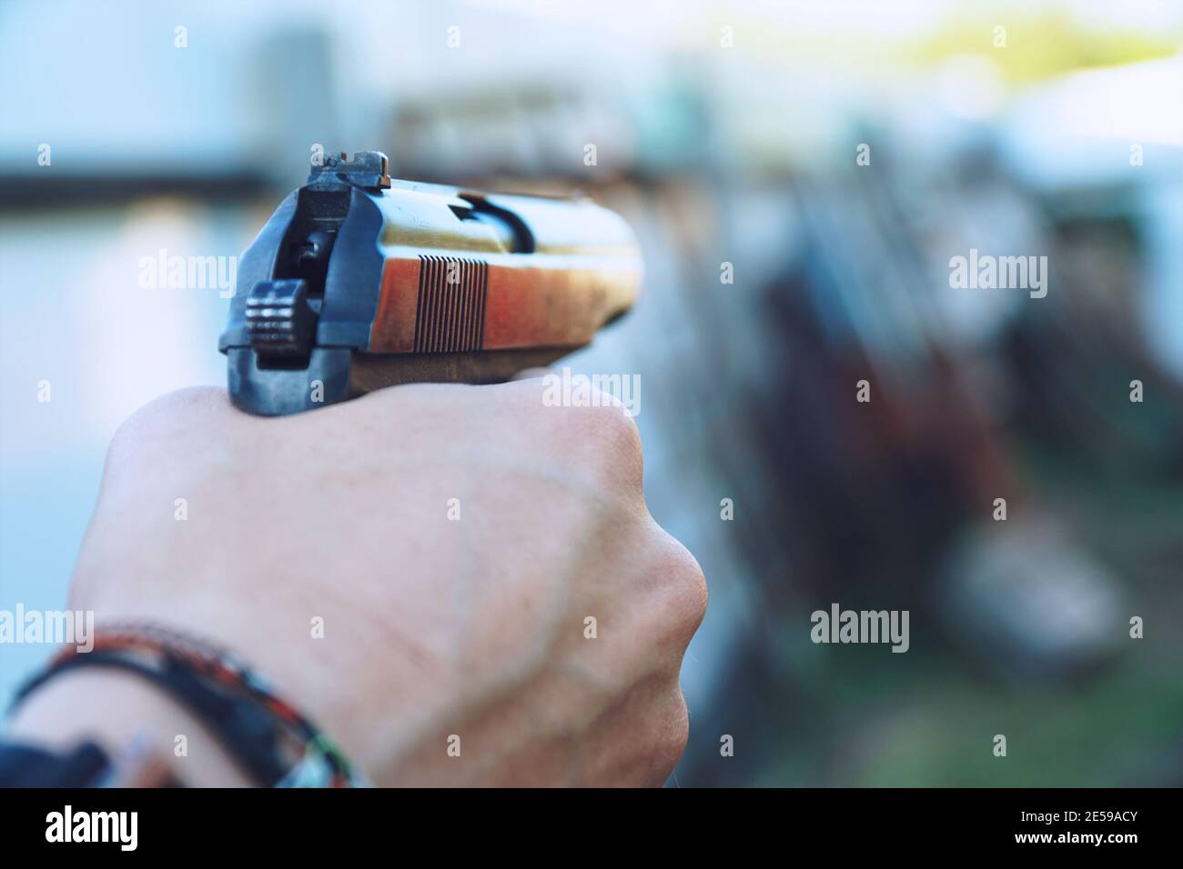 Gun in the hands of a man Stock Photo - Alamy