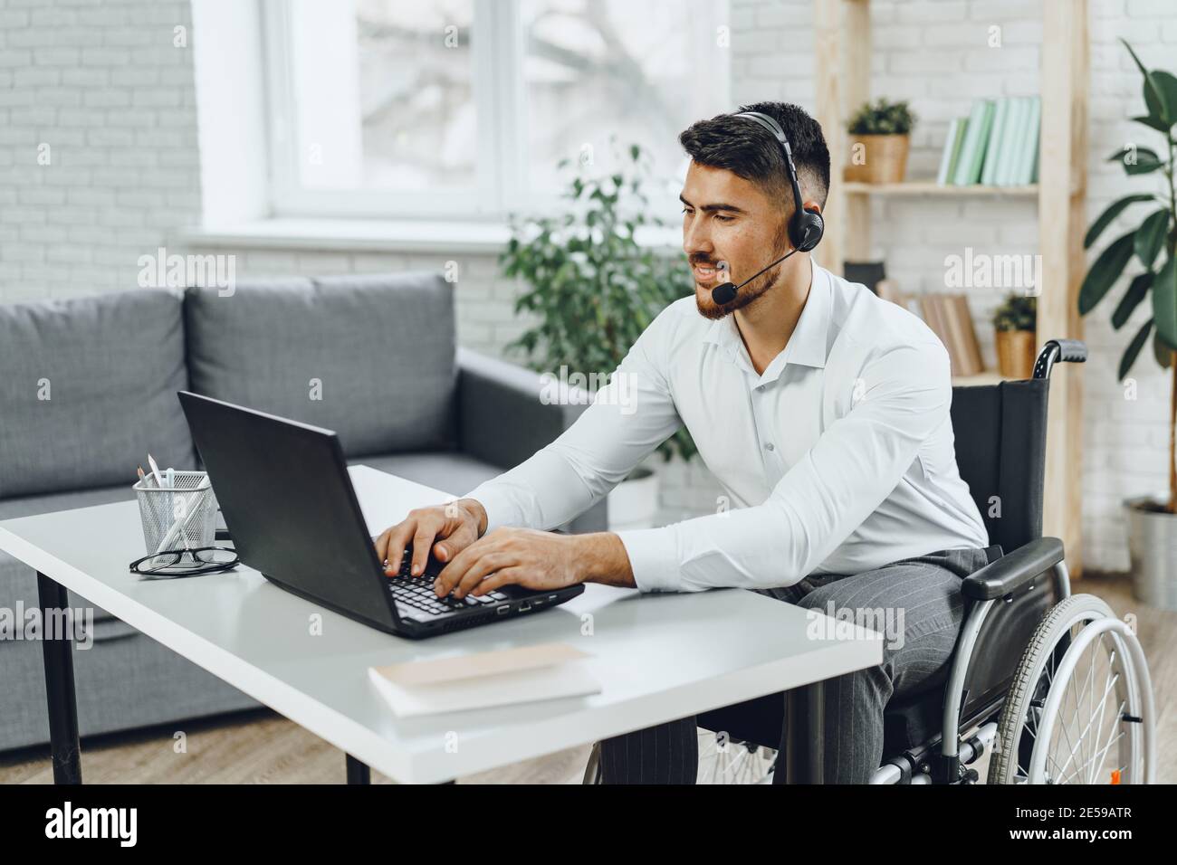 Disabled young man businessman working from home Stock Photo - Alamy