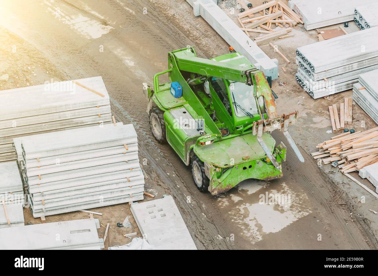 Green lift truck on construction site top view Stock Photo - Alamy