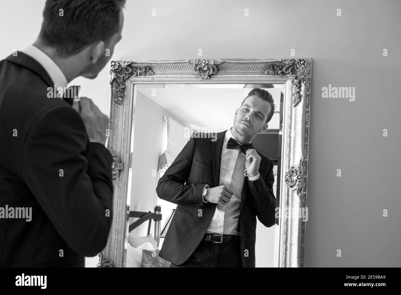 Handsome man wearing tuxedo bowtie hi-res stock photography and images ...