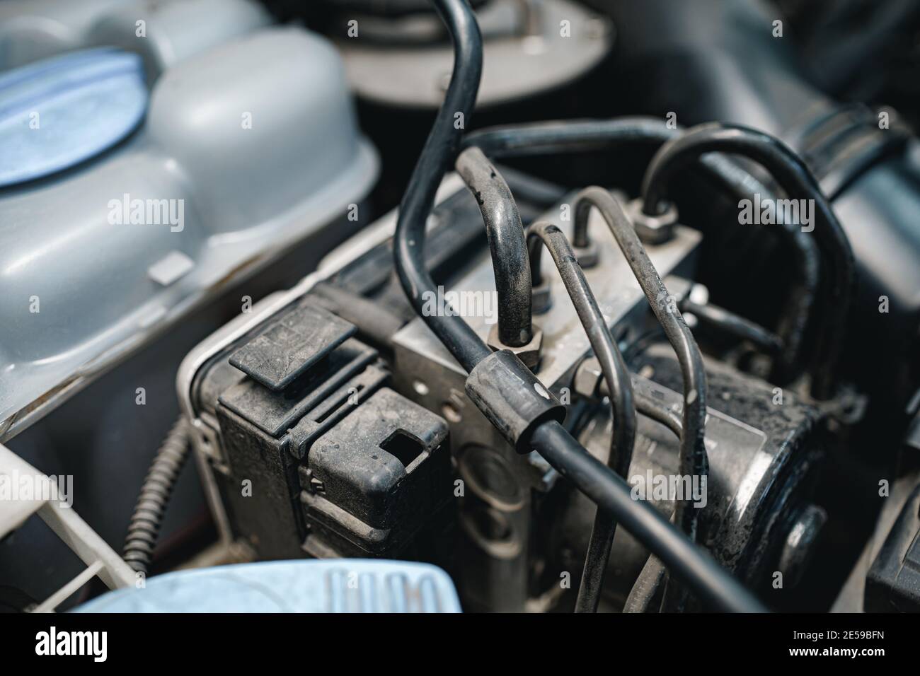 Dirty engine under the hood of a car Stock Photo - Alamy