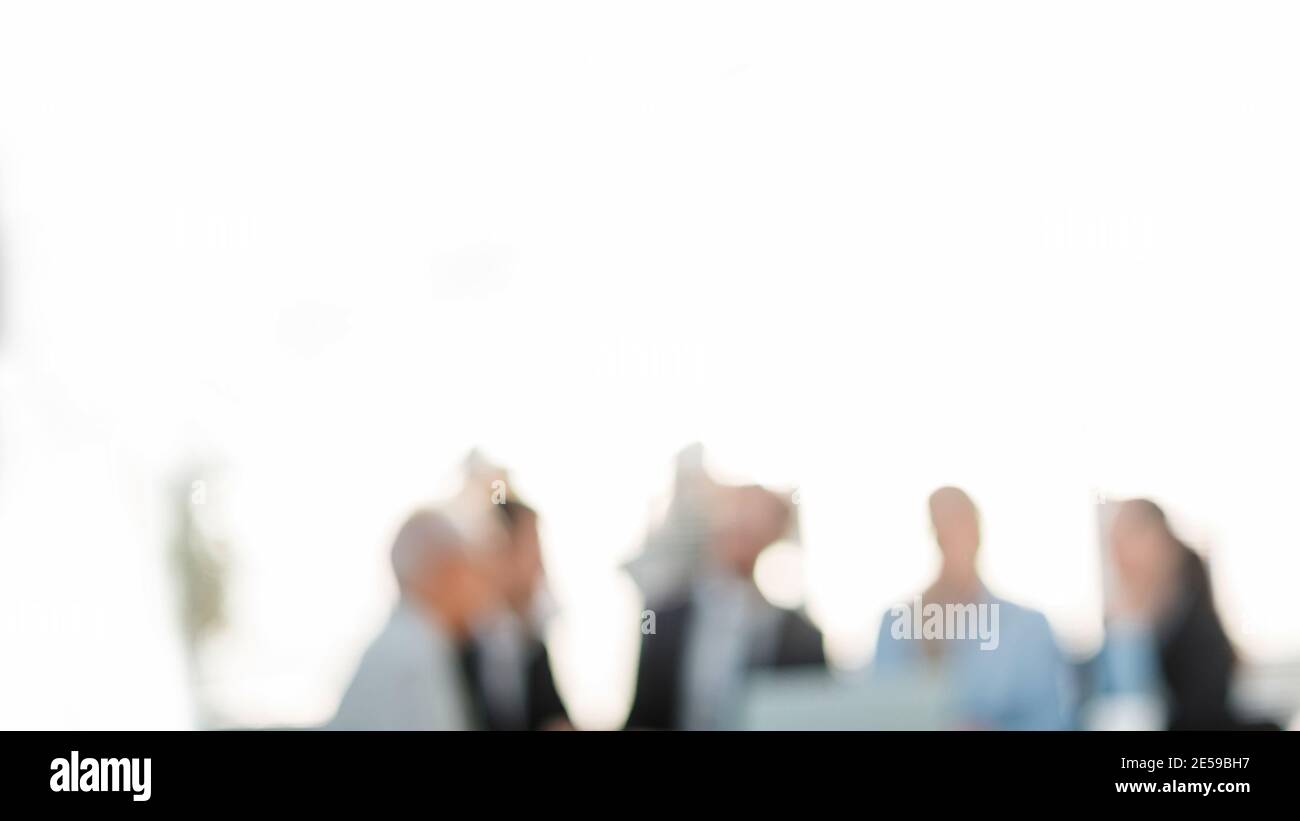 background blurry image of a business team at a work meeting in the ...