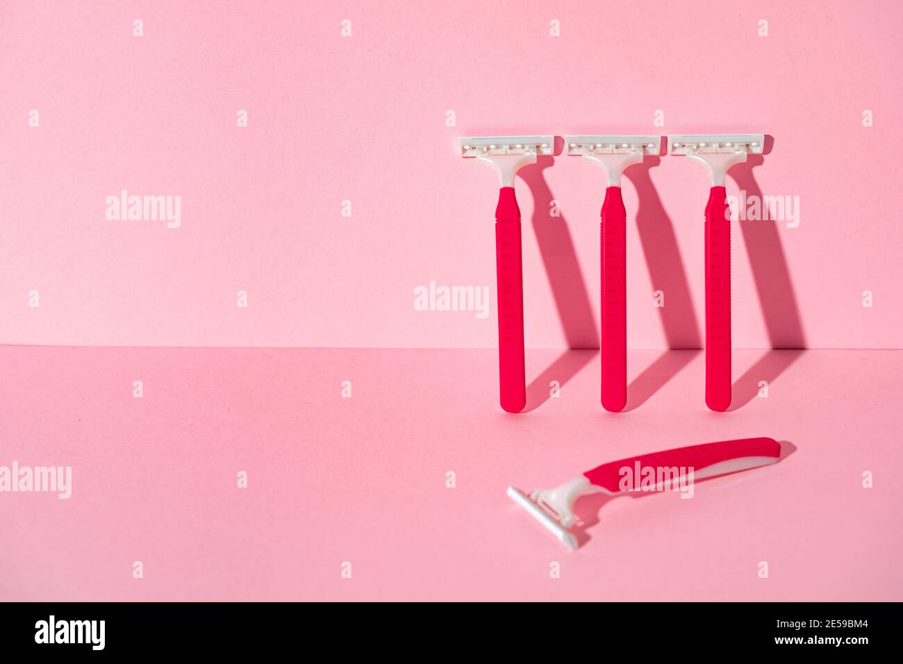Pink disposable razors on pink background, copy space Stock Photo - Alamy