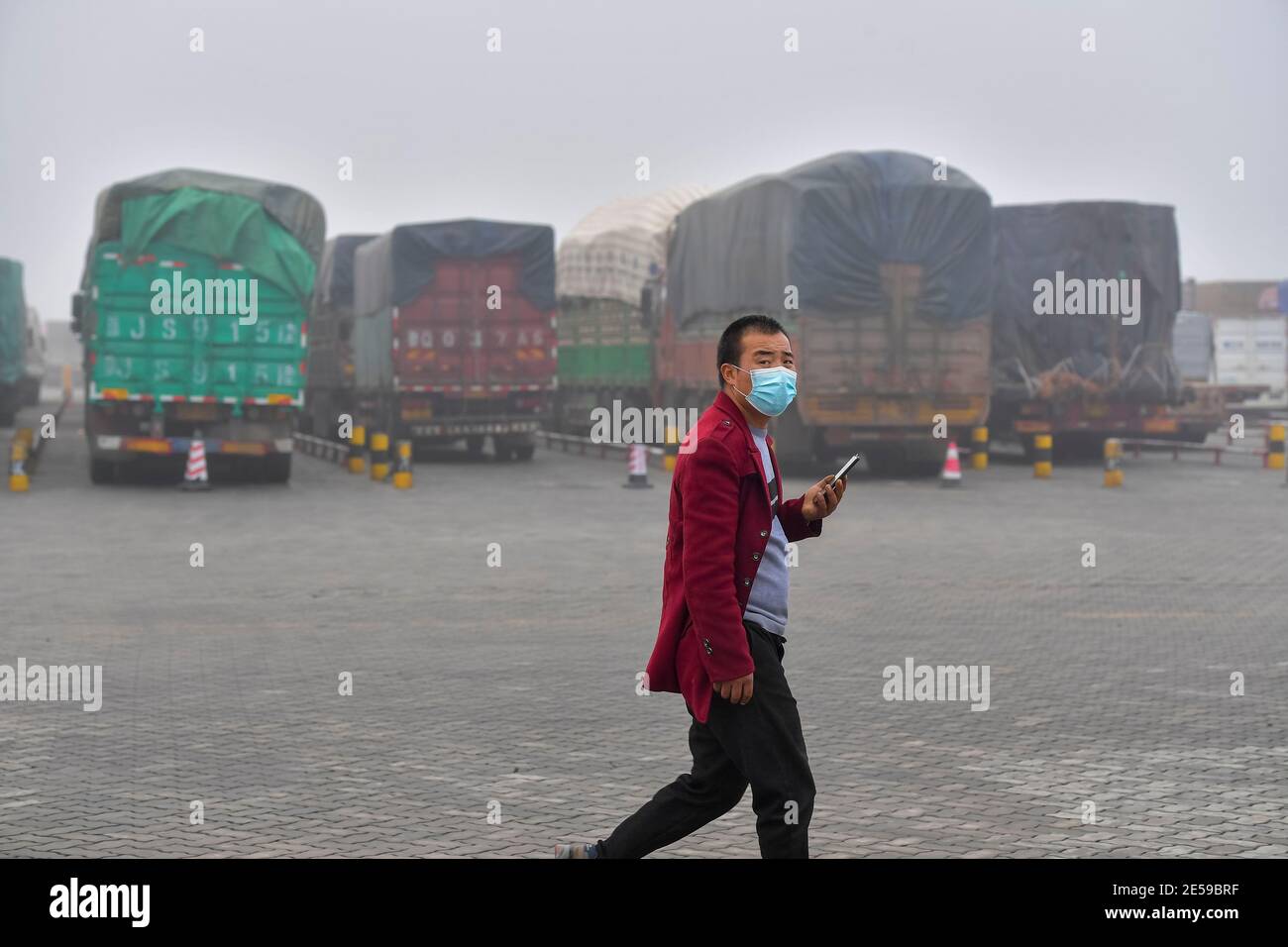 Vehicles line up to cross the sea at the new port in Haikou City, south ...