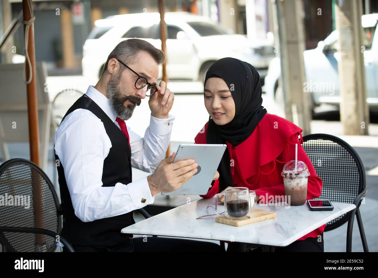 Business people talking in office using digital tablet and social media ...