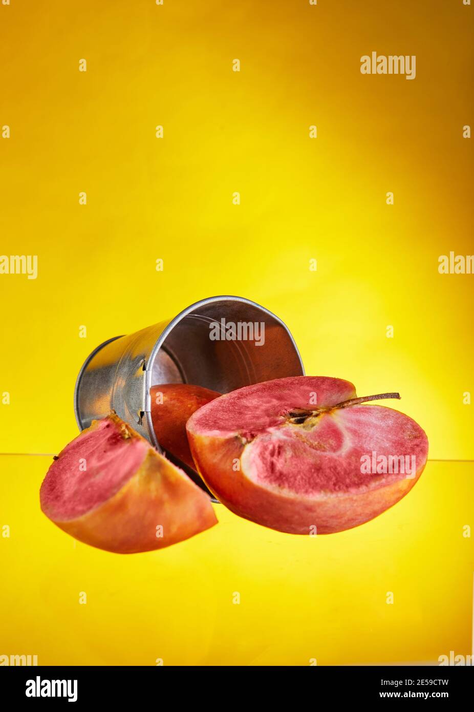 An apple with red pulp inside with a carved wedge on the background of ...