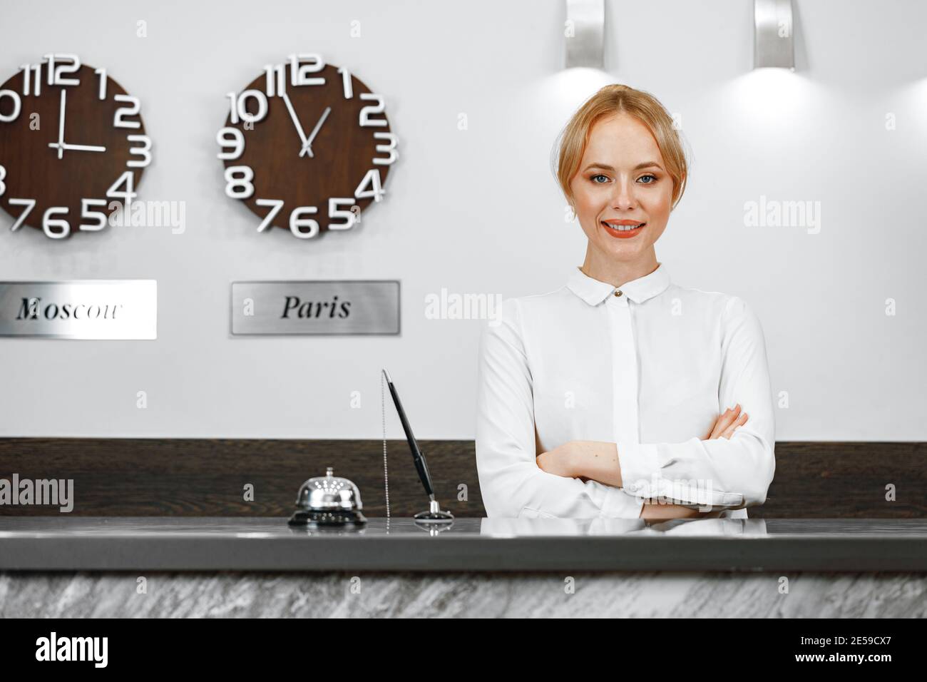 Portrait of beautiful blonde woman hotel receptionist Stock Photo - Alamy