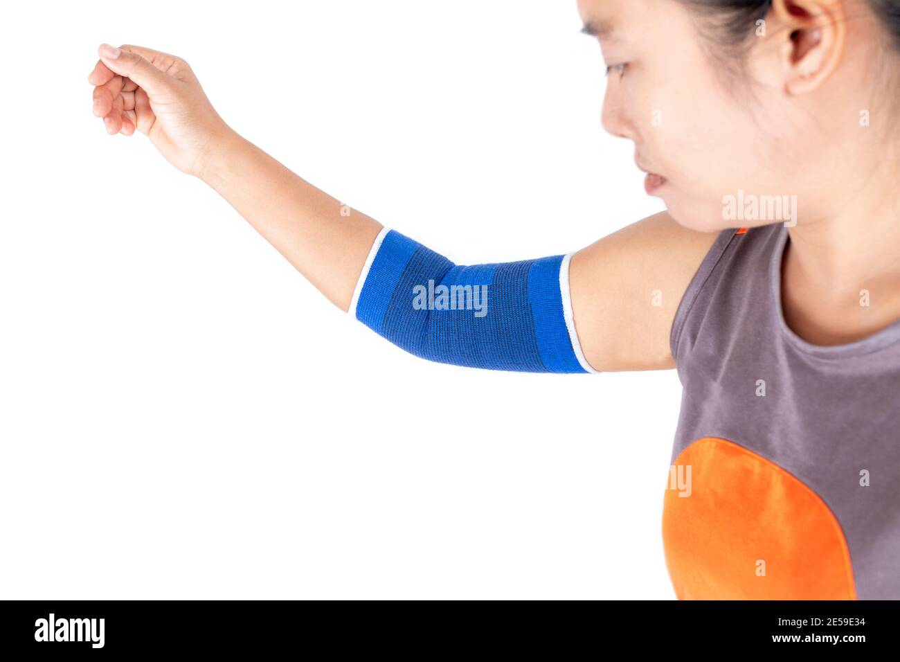 Female wearing elbow support because of injury from exercise, health ...