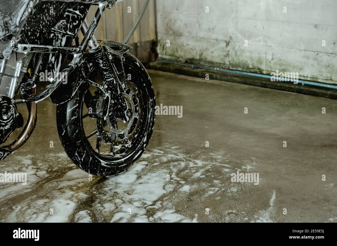 Wash the motorbike at the car wash shop. Foam car wash on wheels Stock ...