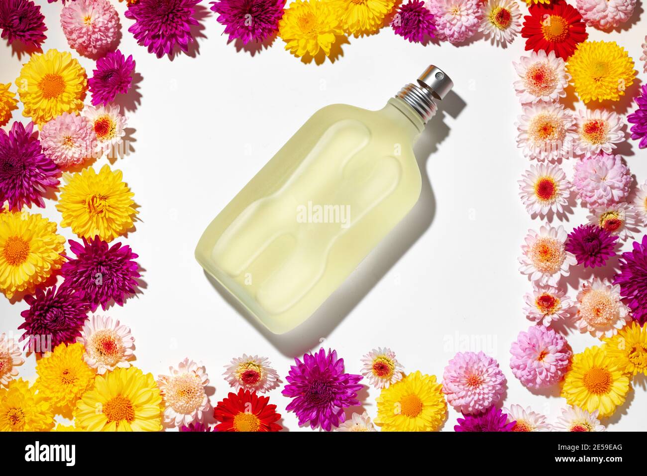 Bottle of fragrance surrounded by flower buds Stock Photo - Alamy