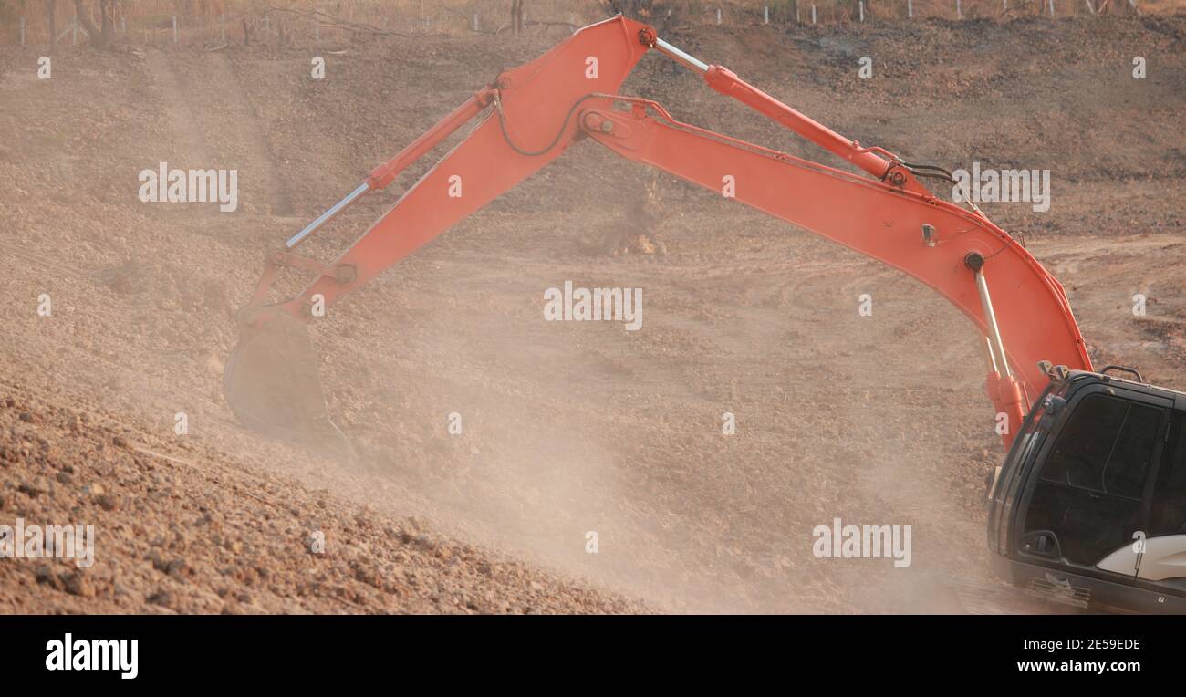 Orange excavator Under construction Large reservoir, Dust by digging ...
