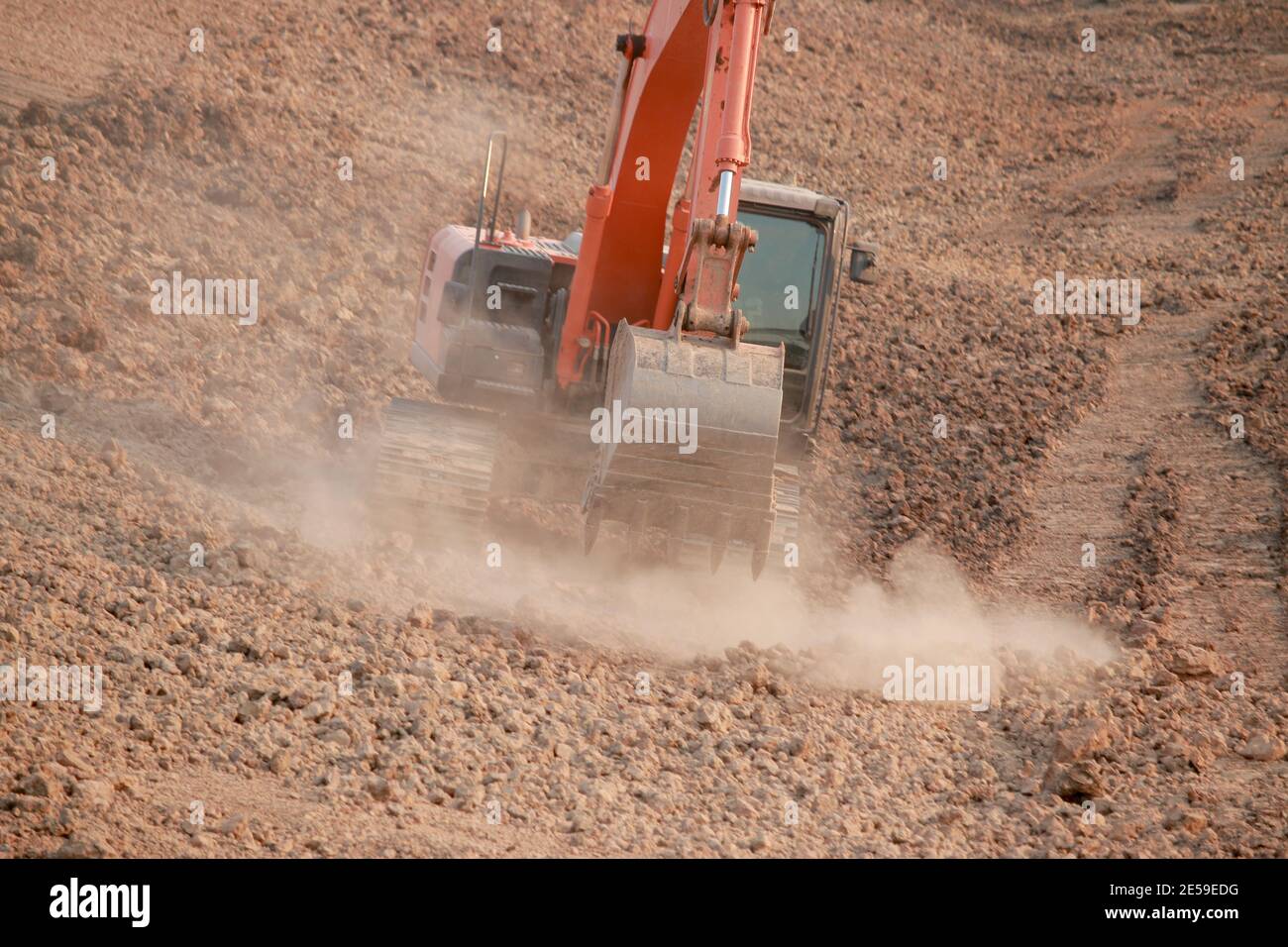 Orange excavator Under construction Large reservoir, Dust by digging ...