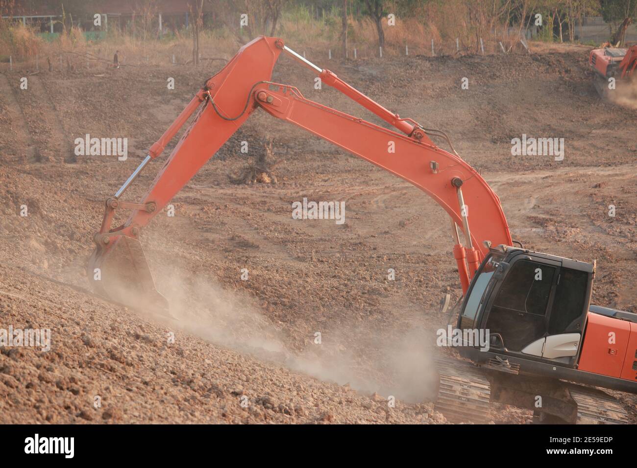 Orange excavator Under construction Large reservoir, Dust by digging ...