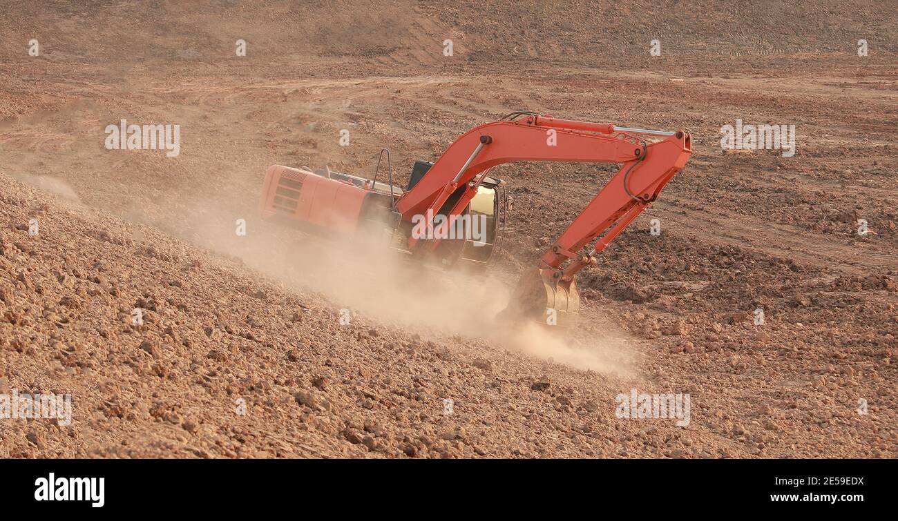 Orange excavator Under construction Large reservoir, Dust by digging ...