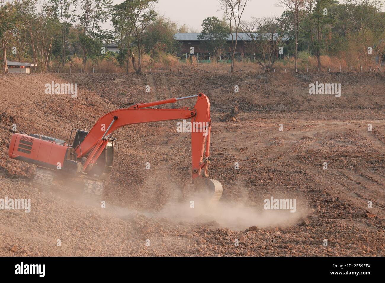 Orange excavator Under construction Large reservoir, Dust by digging ...