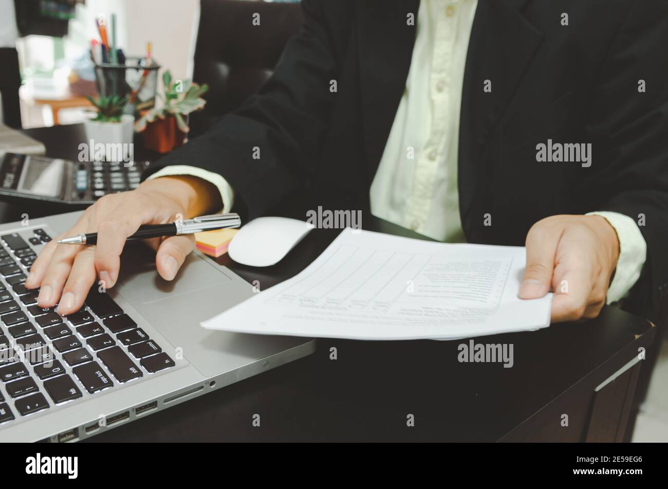 Business men use computers to look at financial data, marketing, sales ...