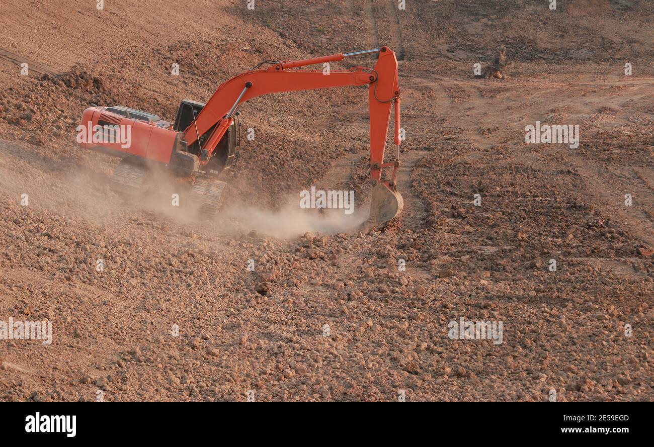 Orange excavator Under construction Large reservoir, Dust by digging ...