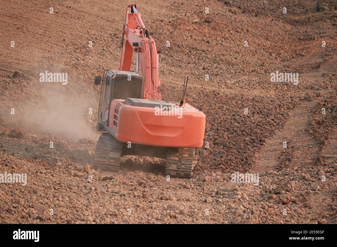 Orange excavator Under construction Large reservoir, Dust by digging ...