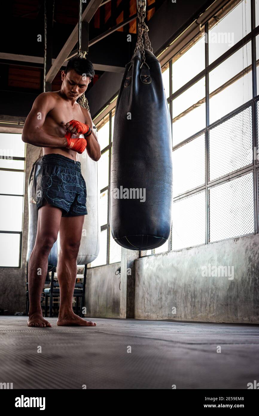 Man boxer wrapping his hand in boxing arena sport Stock Photo - Alamy