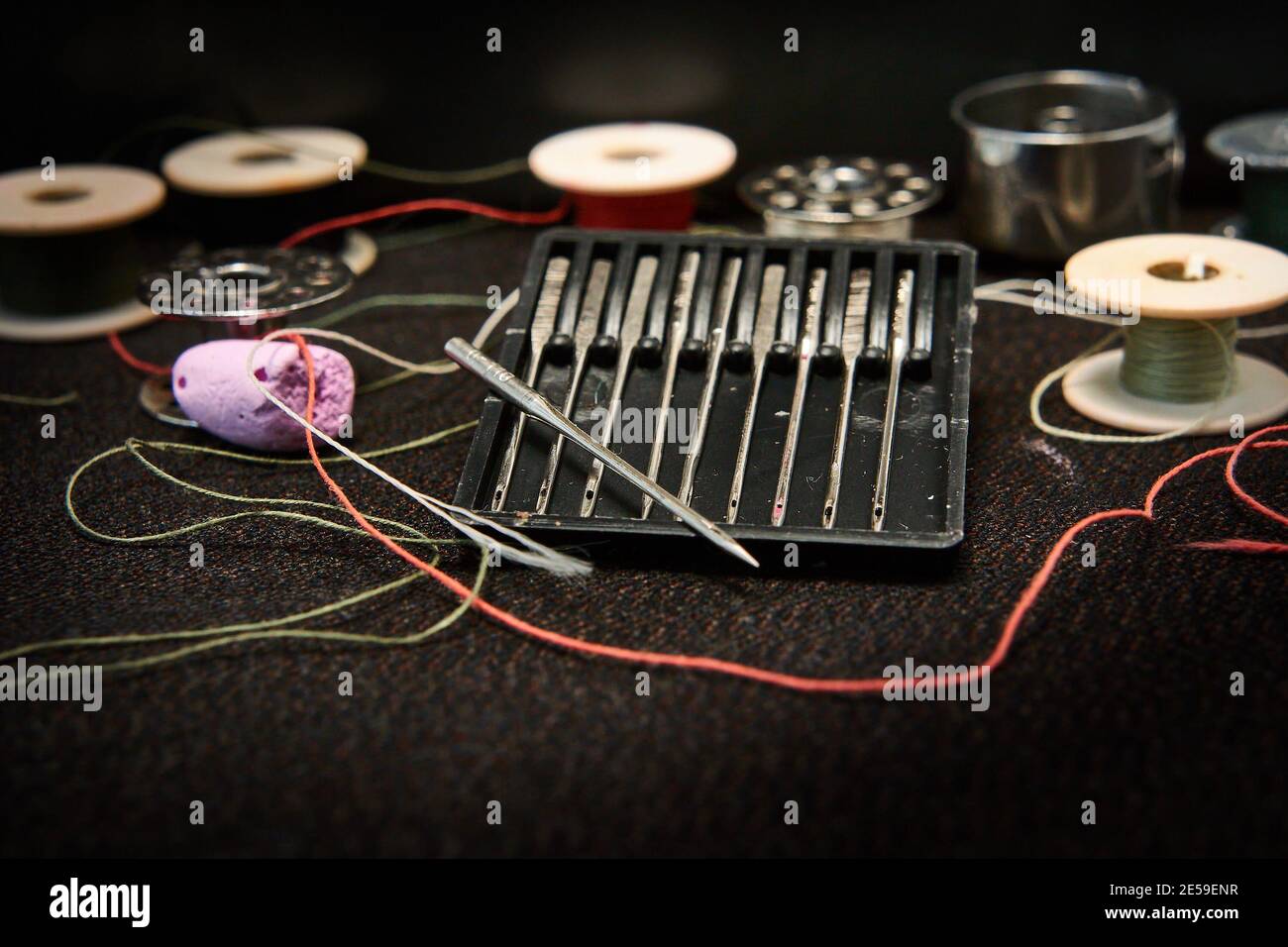 Set of needles and threads for a sewing machine Stock Photo - Alamy
