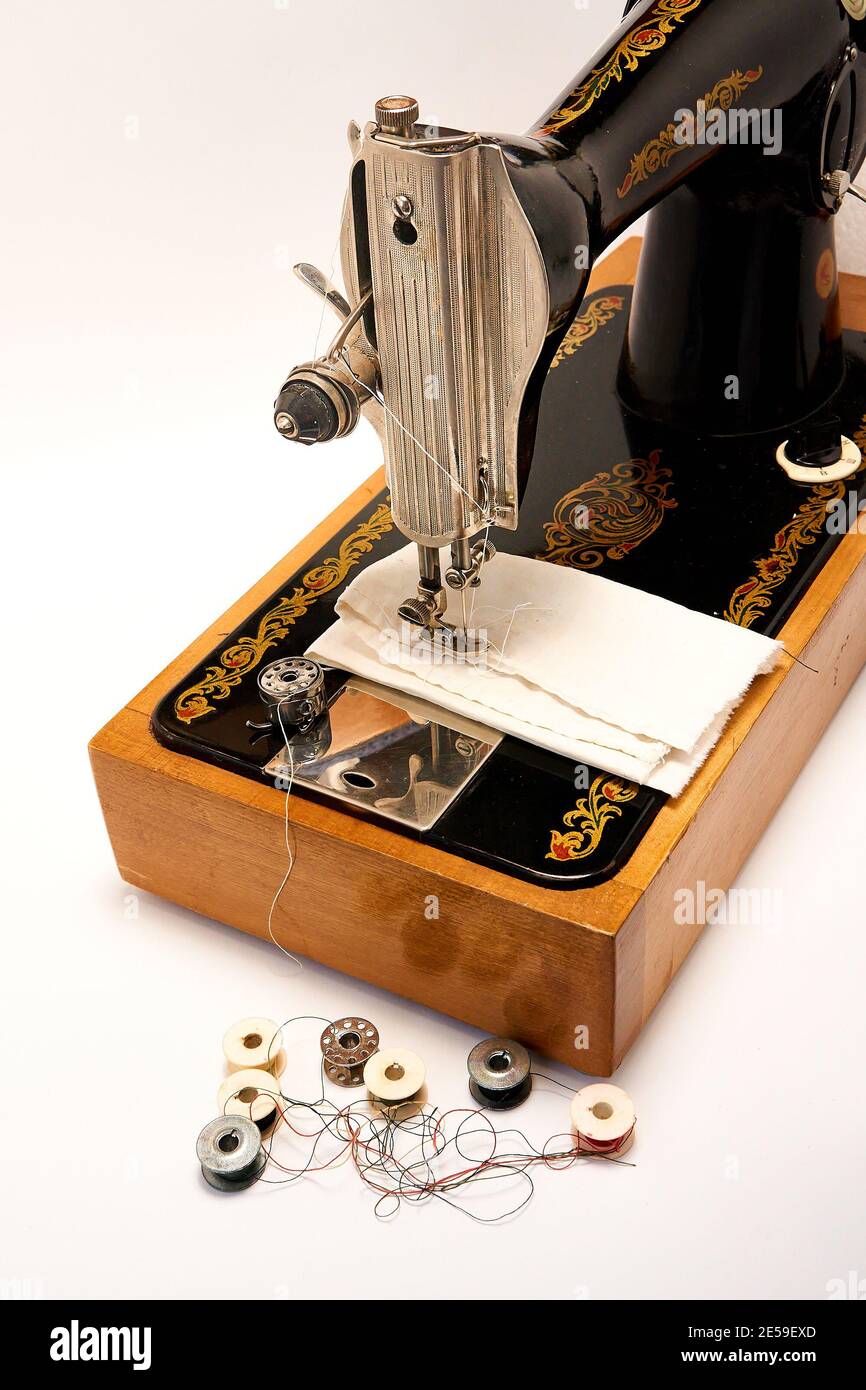 Sewing machine and parts on a white background Stock Photo - Alamy