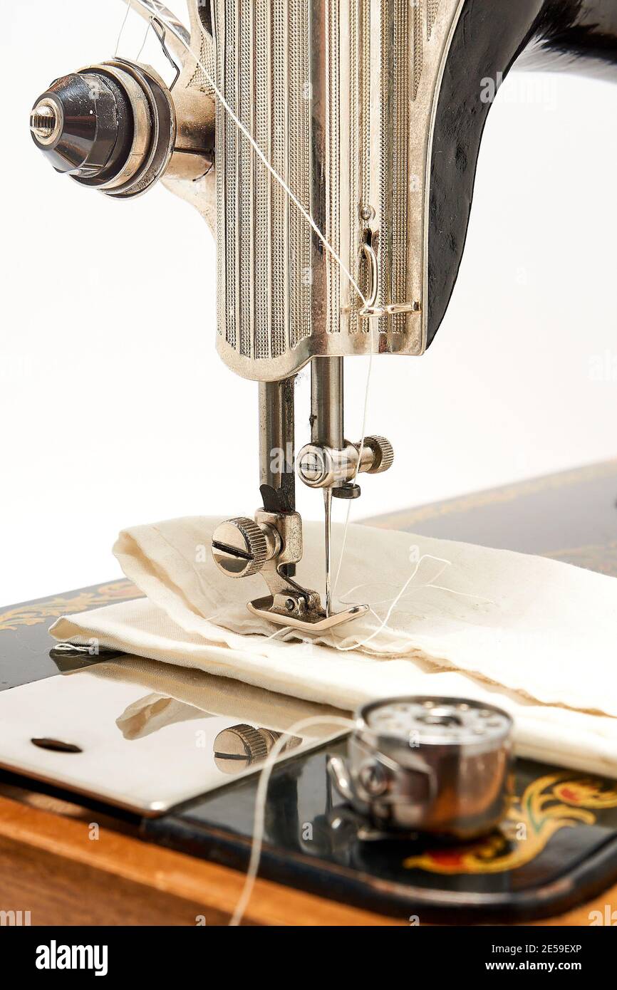 Sewing machine and parts on a white background Stock Photo - Alamy