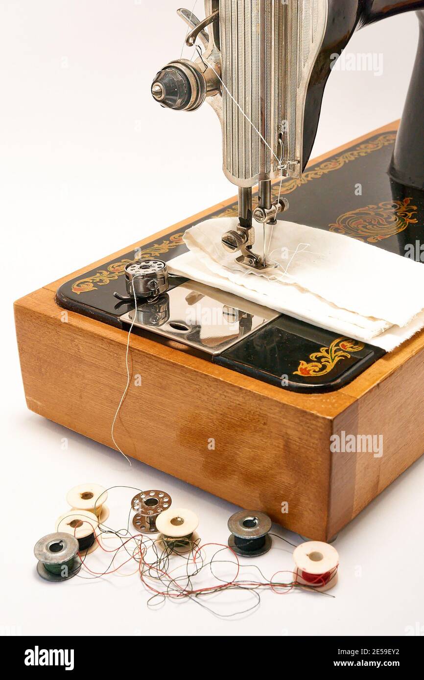Sewing machine and parts on a white background Stock Photo - Alamy