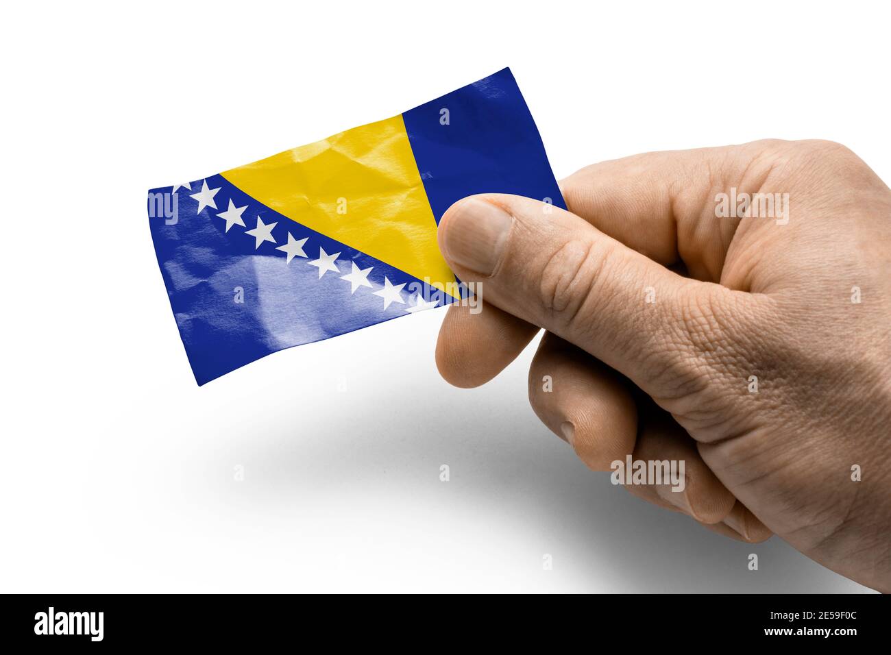 Hand holding a card with a national flag the Bosnia and Herzegovina ...