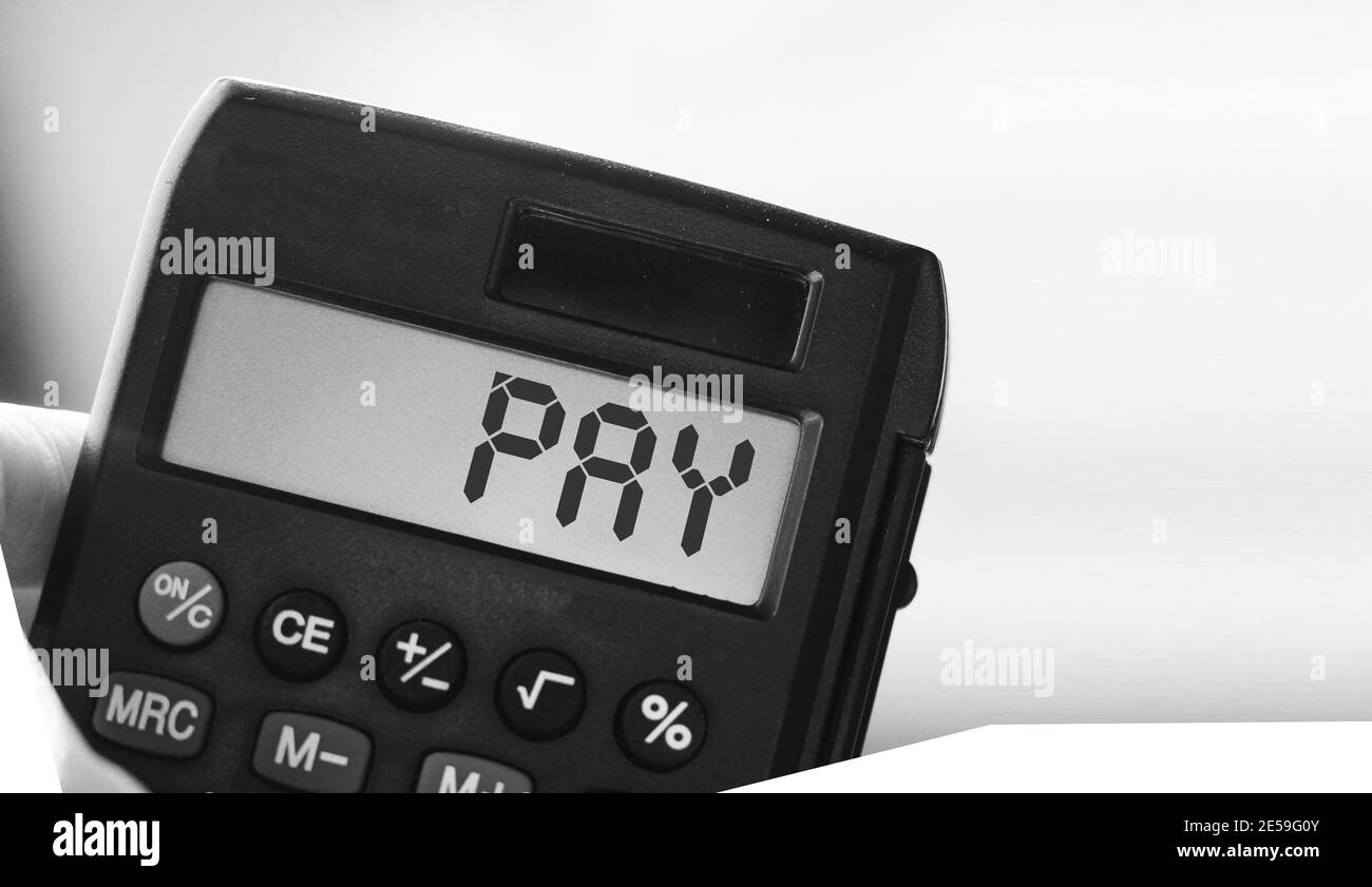 Pay word on calculator display. Business and tax concept Stock Photo ...