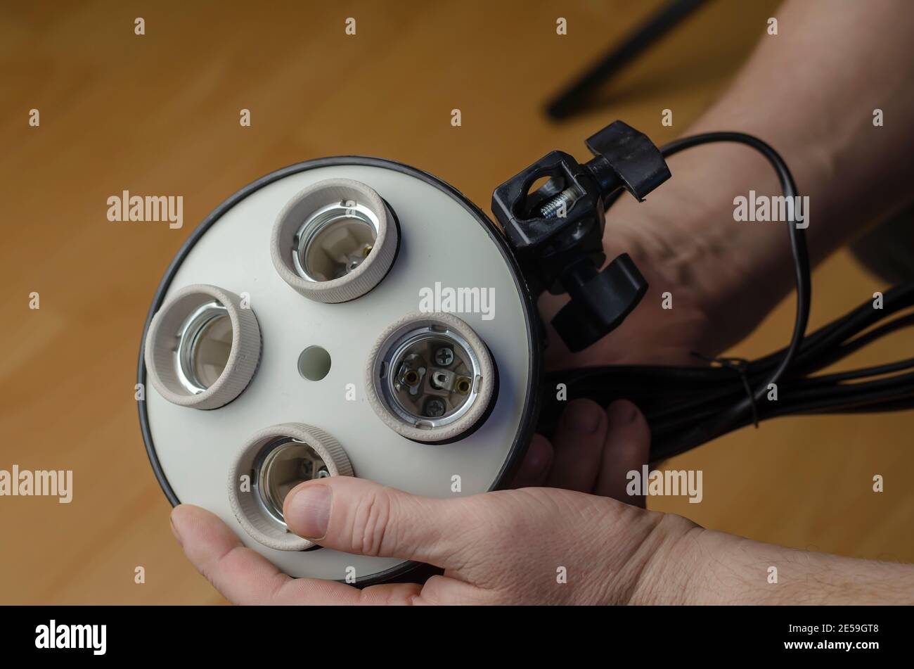 Man's Hand Holds New 4-Lamp Holder. Softbox holder, photo equipment ...