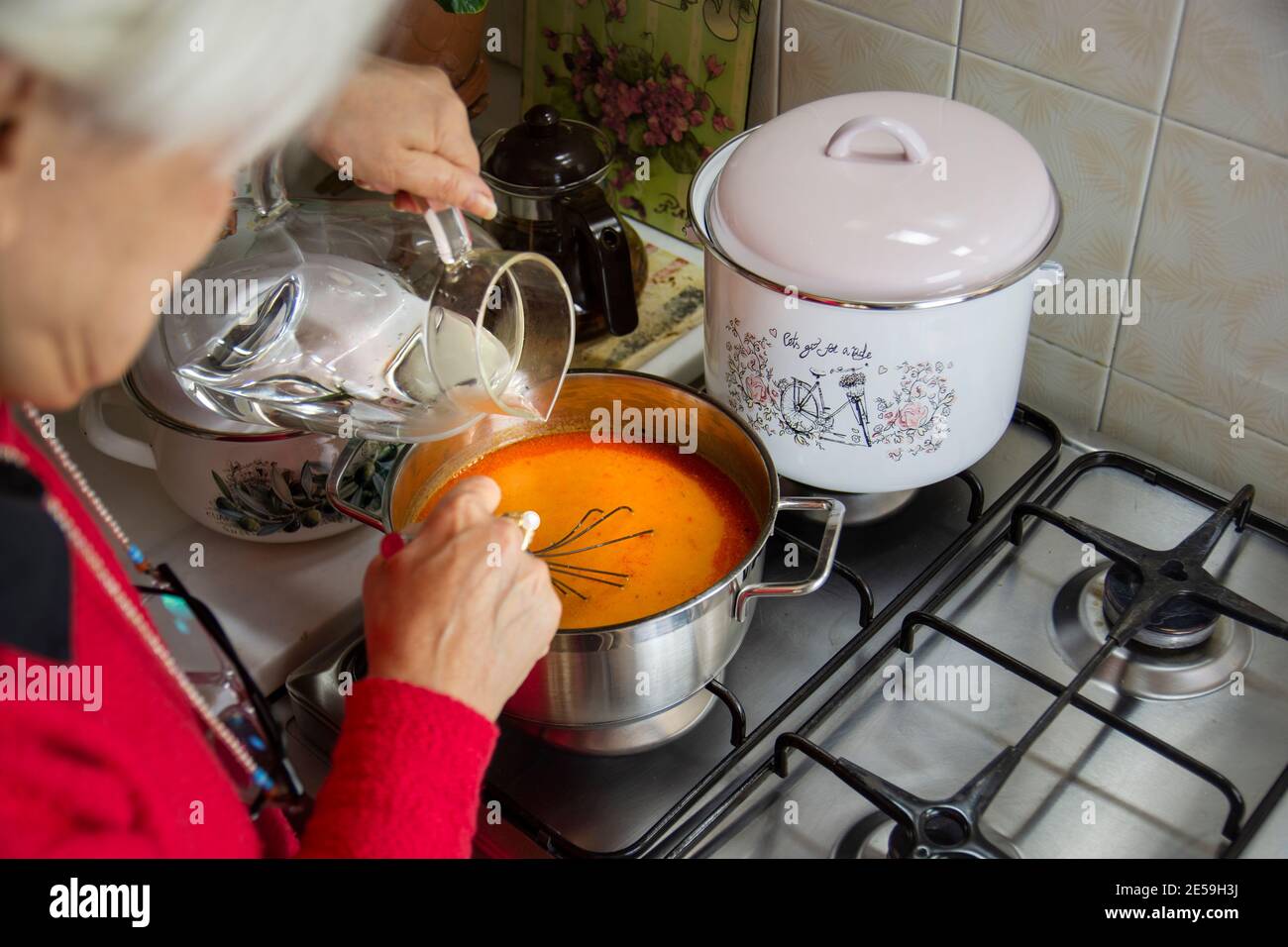 Old lady cooking hi-res stock photography and images - Alamy