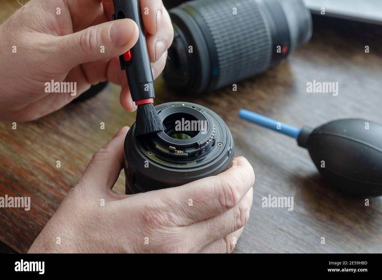Care of photographic equipment. Cleaning the lens from dust. Men's ...