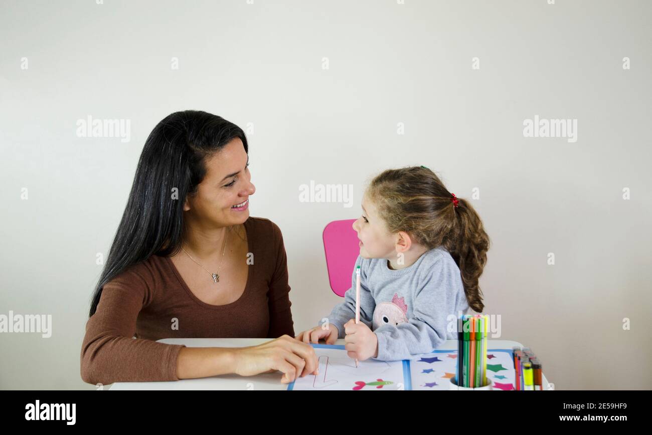 child and woman studying, and looking each other education at pandemic ...