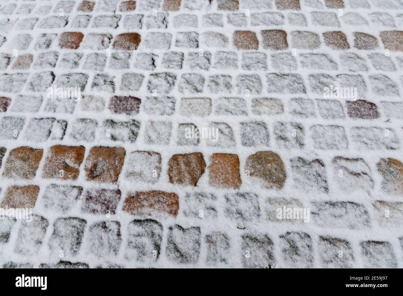 Cobblestones under snow for background Stock Photo - Alamy