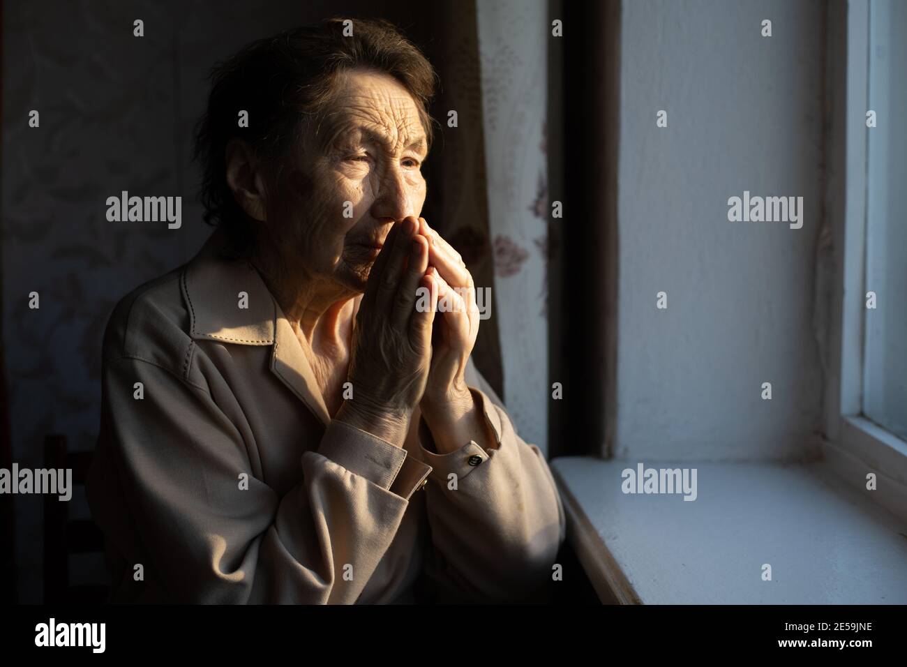 Close up portrait of an old woman praying Stock Photo - Alamy