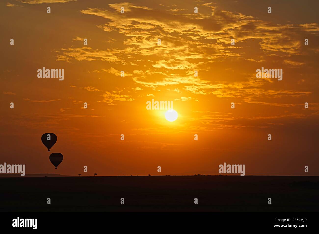 Sunset, hot air balloon silhouette, meadows and mountains. Large ...