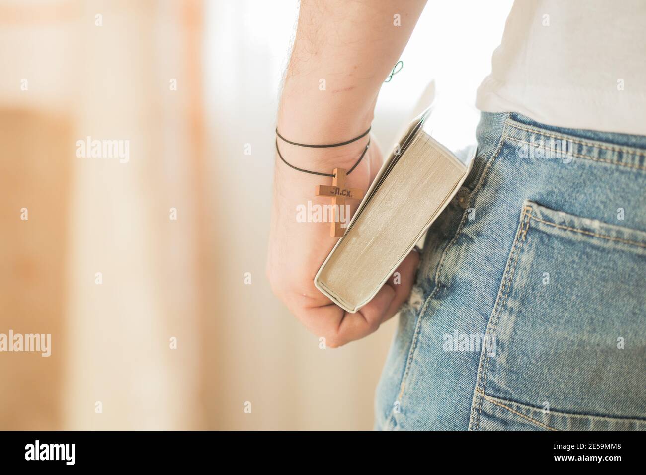 Man holding holy bible over gray background for copy concept for ...