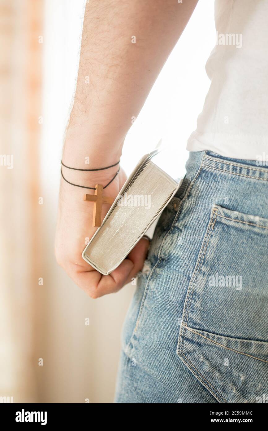 Man holding holy bible over gray background for copy concept for ...