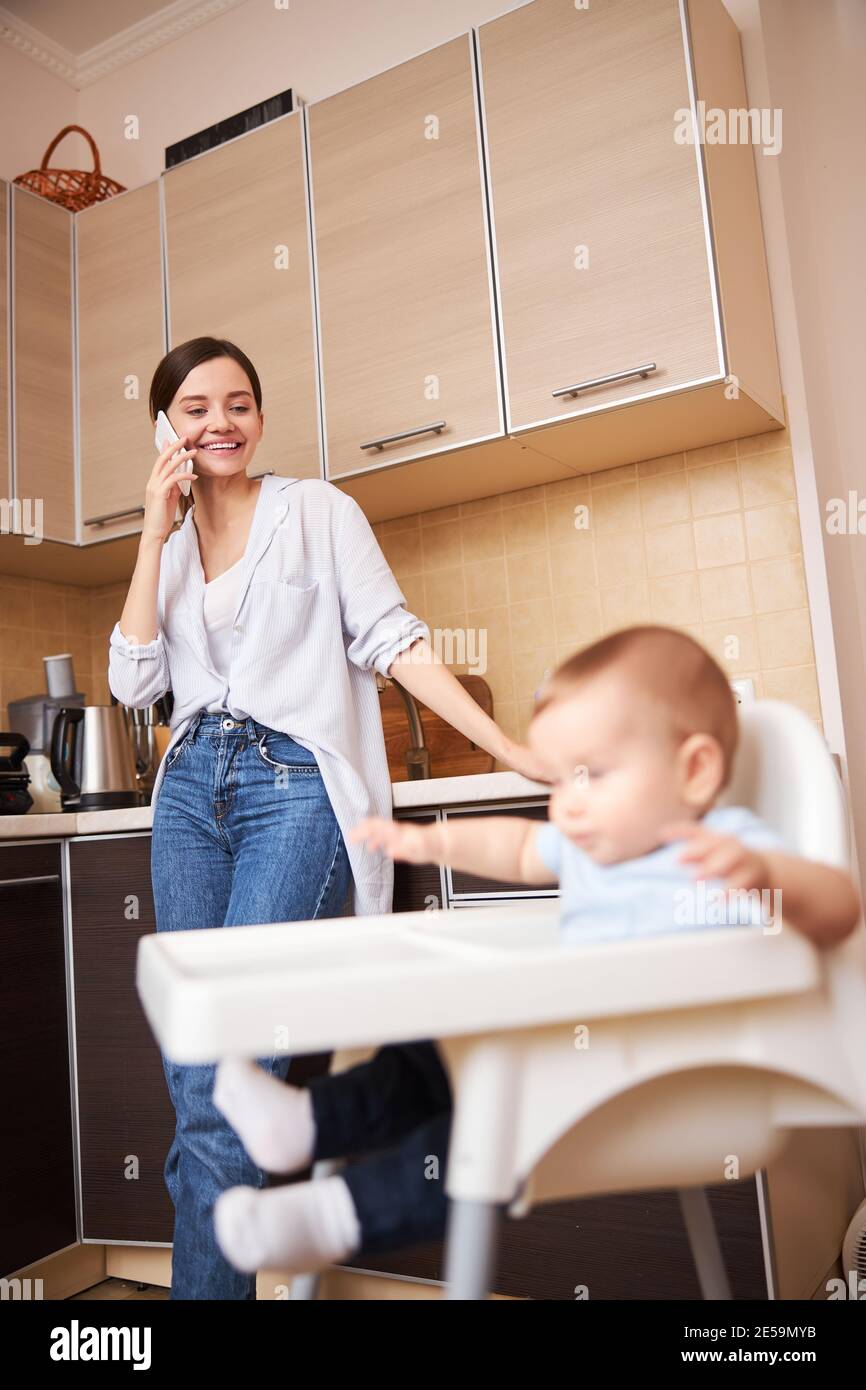 Little boy sitting in his chair for babies Stock Photo - Alamy