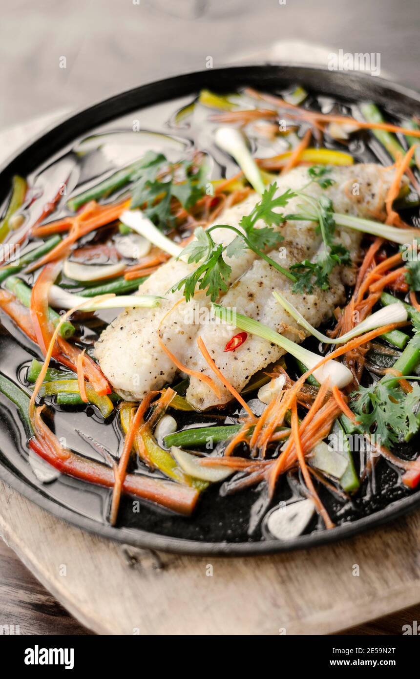 chinese cantonese style steamed spicy fish fillet with vegetables on ...
