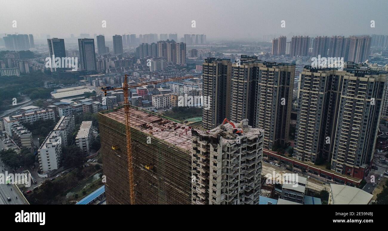 NANNING, CHINA - JANUARY 27, 2021 - An excavator demolish the roof of a ...