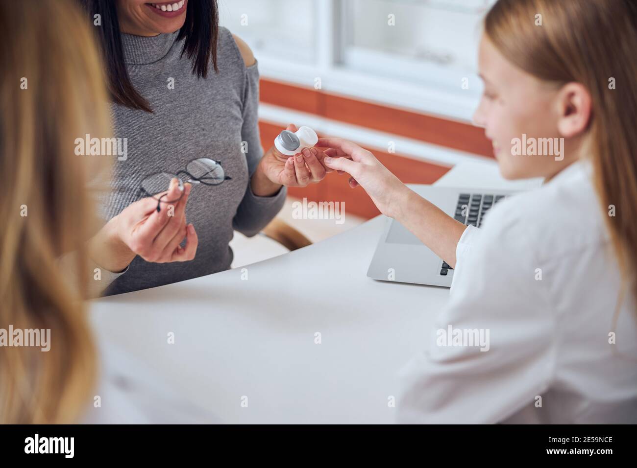 Focused image of female demonstrating lens and eye glass Stock Photo ...