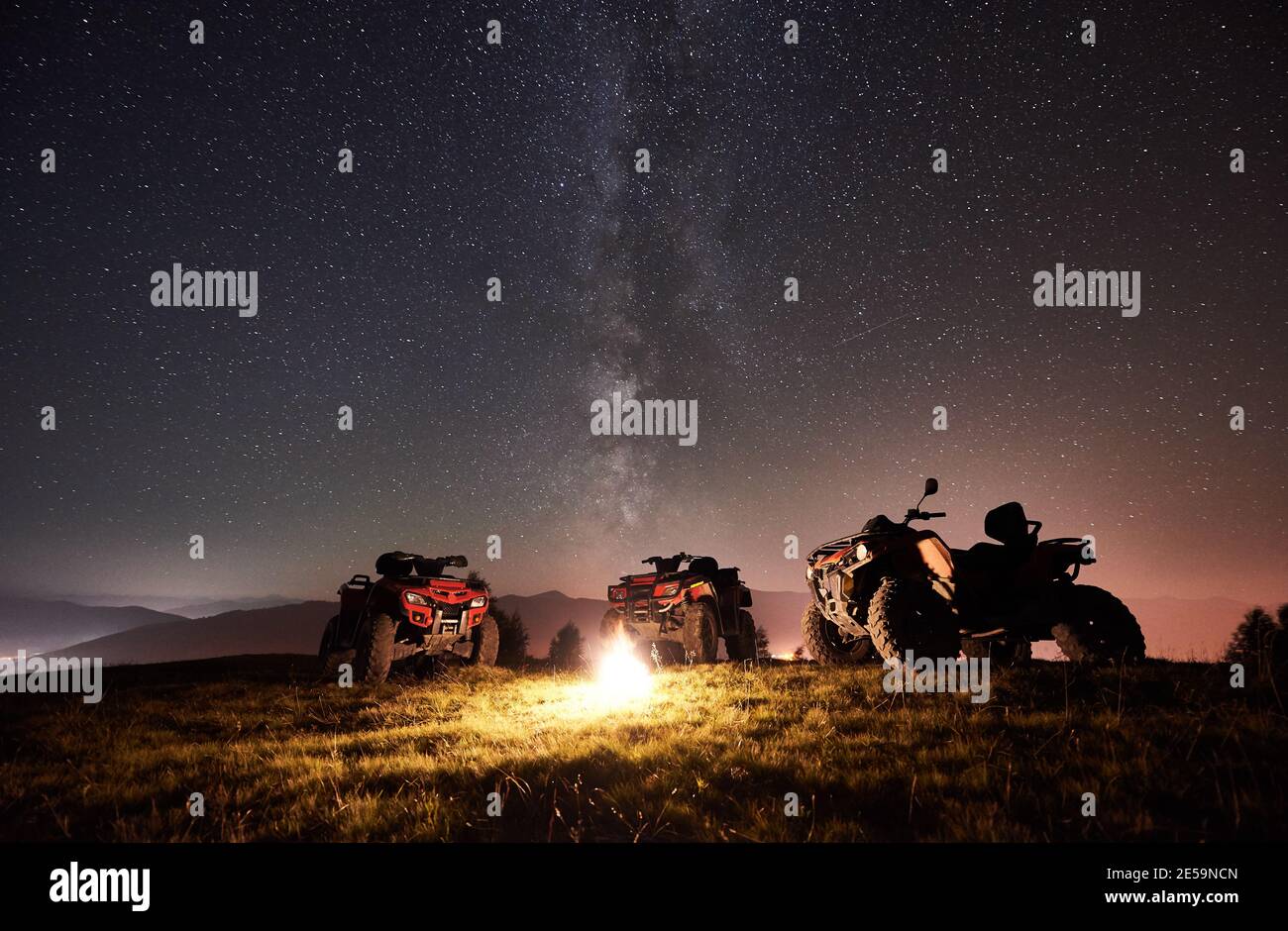Night picture. Three atv quad motorbikes standing on the top of ...