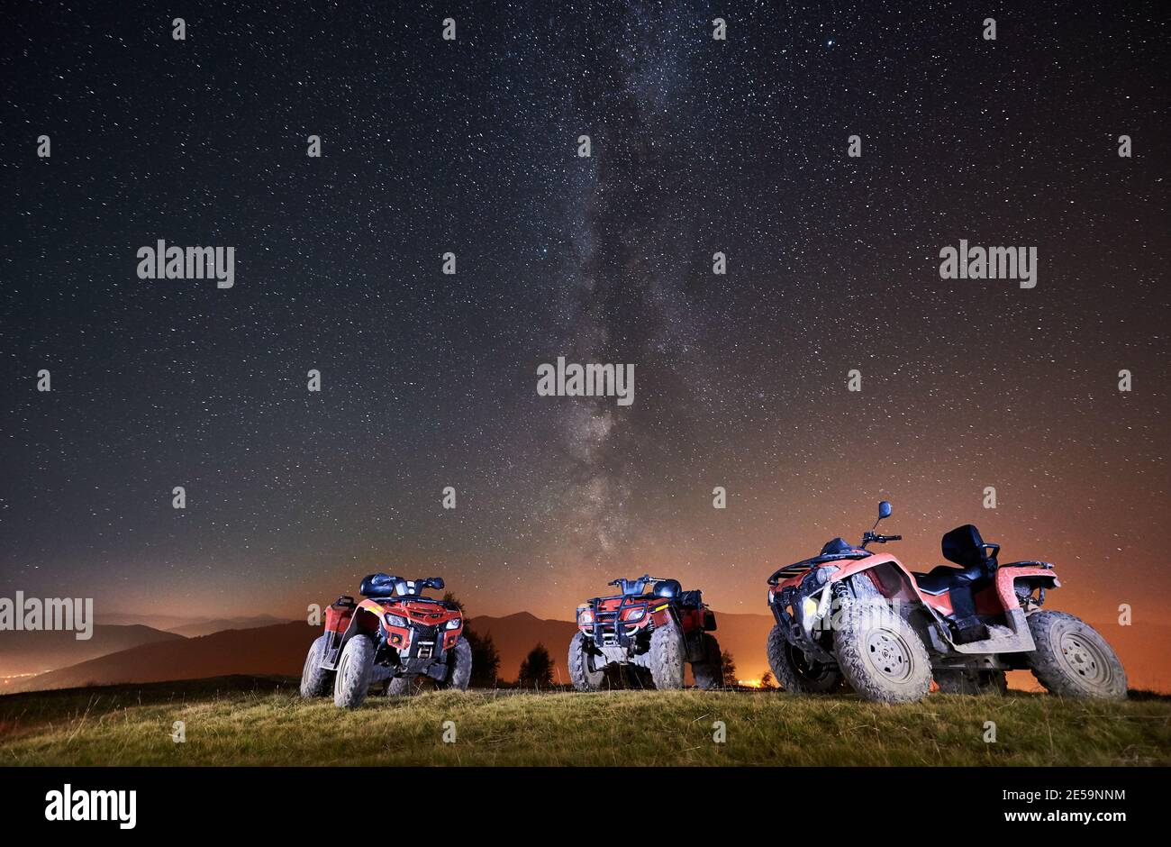 Night picture. Three atv quad motorbikes standing on the top of ...