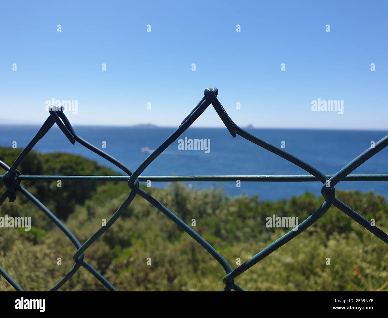 rusty wire fence, sky and sea. migration to new life Stock Photo - Alamy