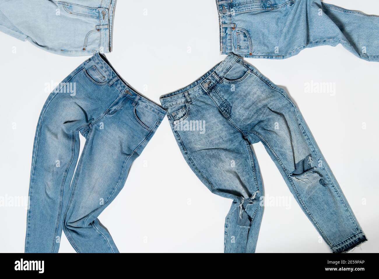 top view of various denim jeans on white background Stock Photo - Alamy