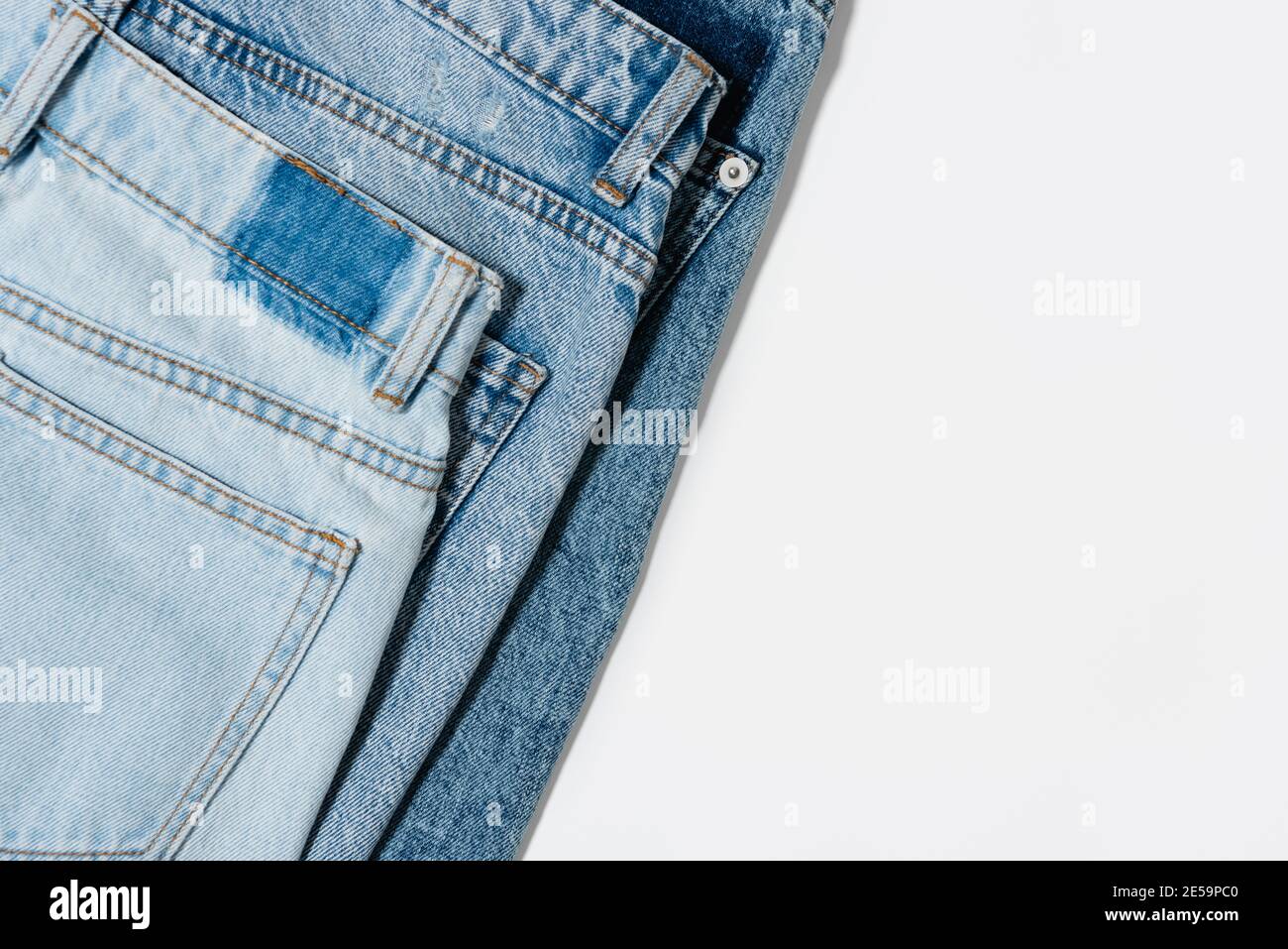 top view of various blue jeans on white background Stock Photo - Alamy